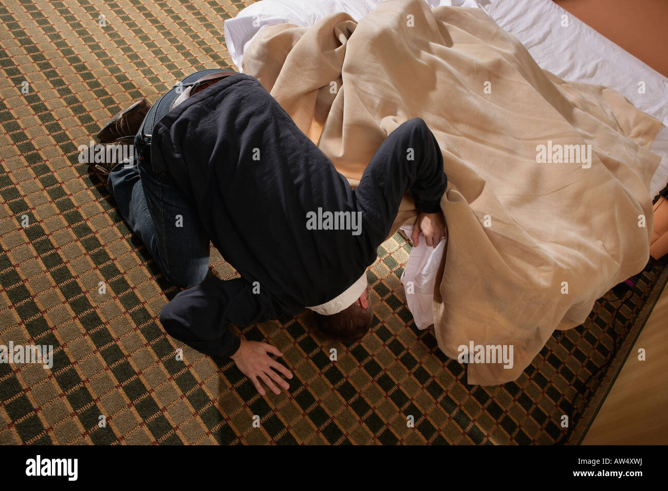 Man looking under covers bed hi-res stock photography and images - Alamy