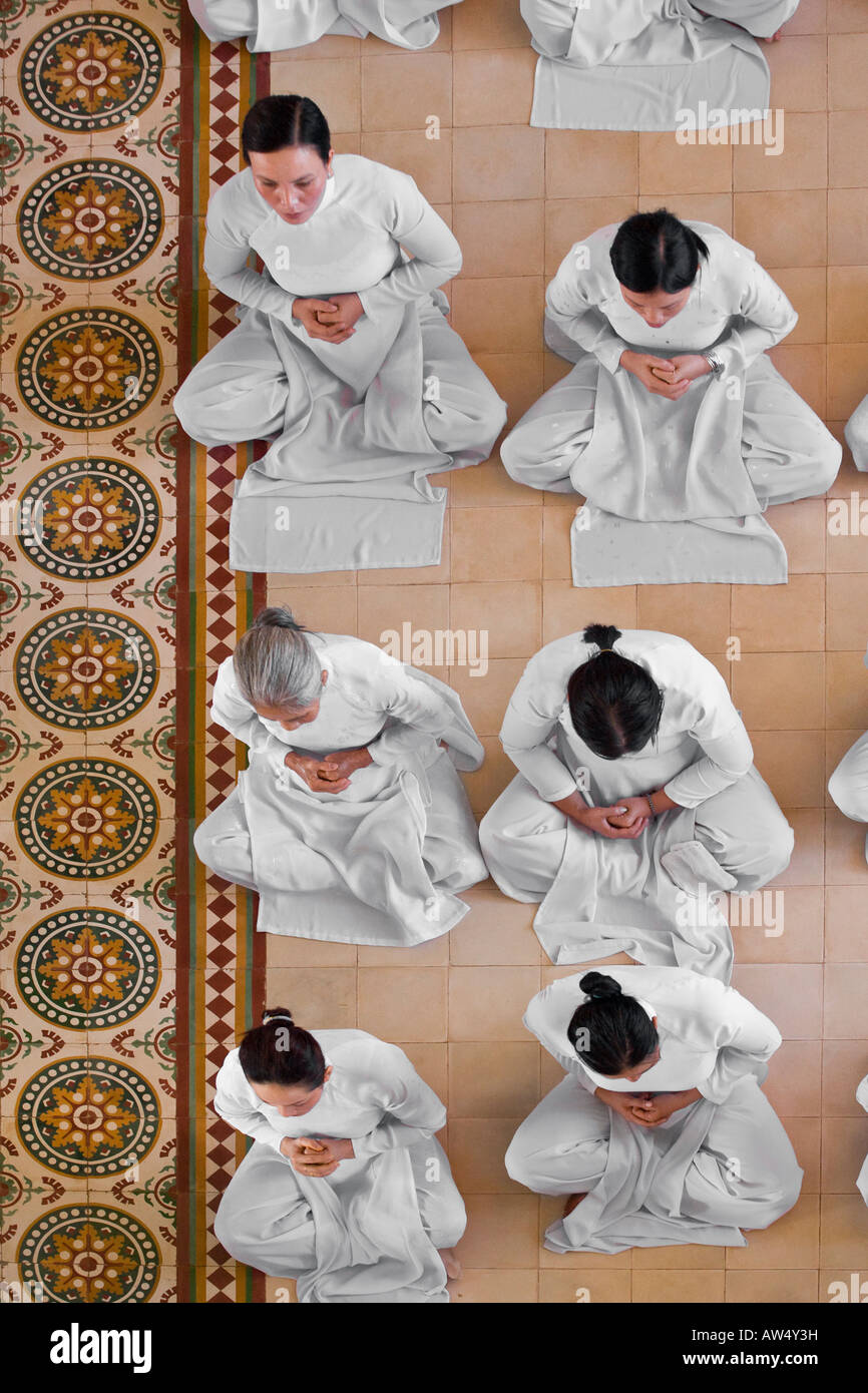 Lay worshipers during a prayer ceremony inside the CAO DAI GREAT TEMPLE ...
