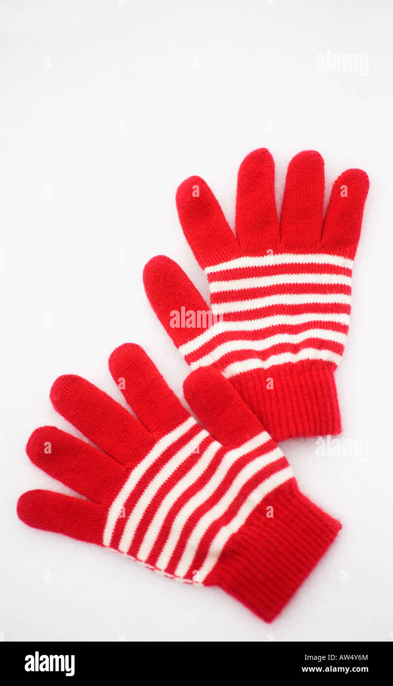 A pair of red and white gloves laying on the snow Stock Photo - Alamy