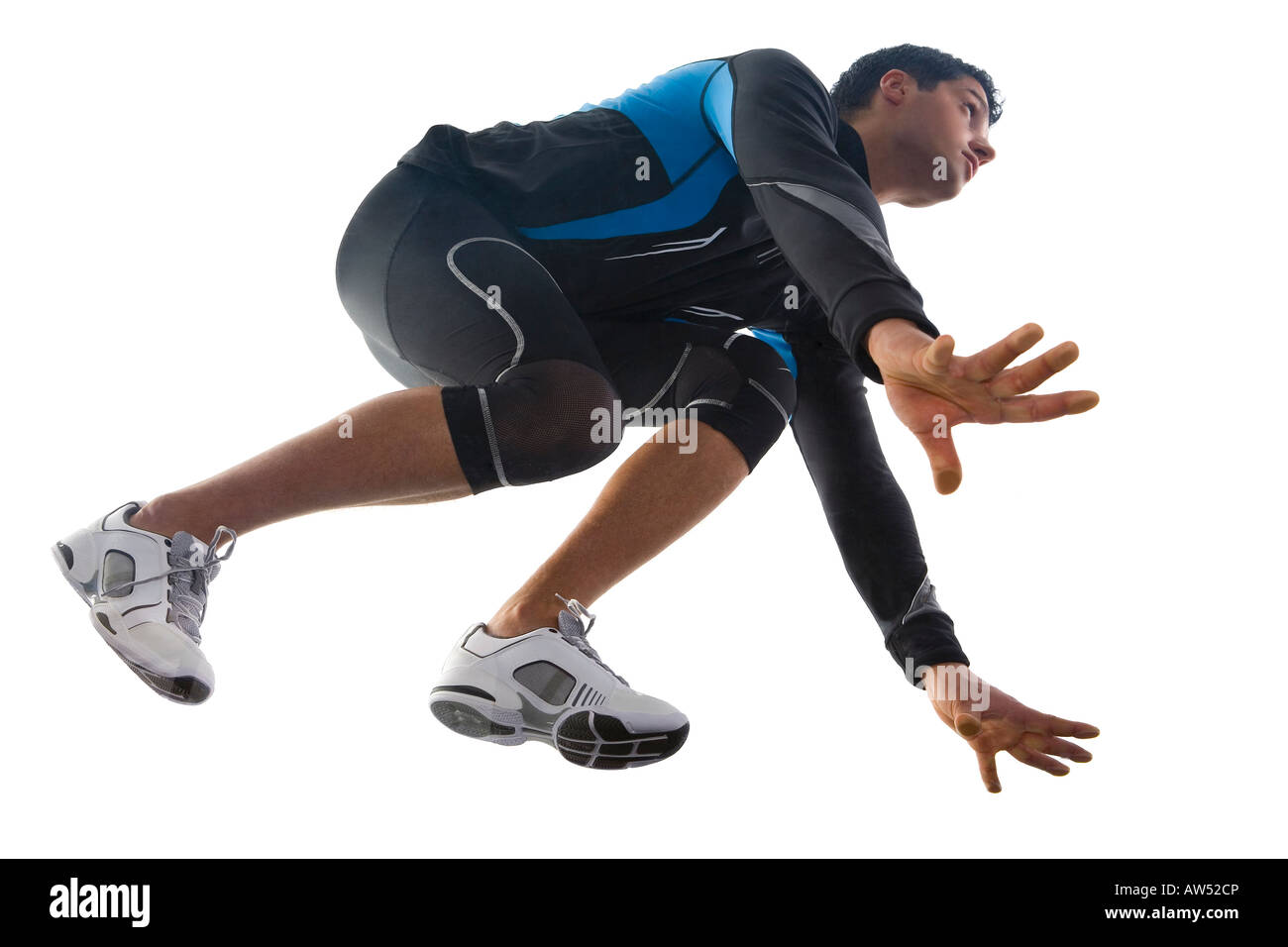 Young runner preparing to race Squatting and looking at something Low ...