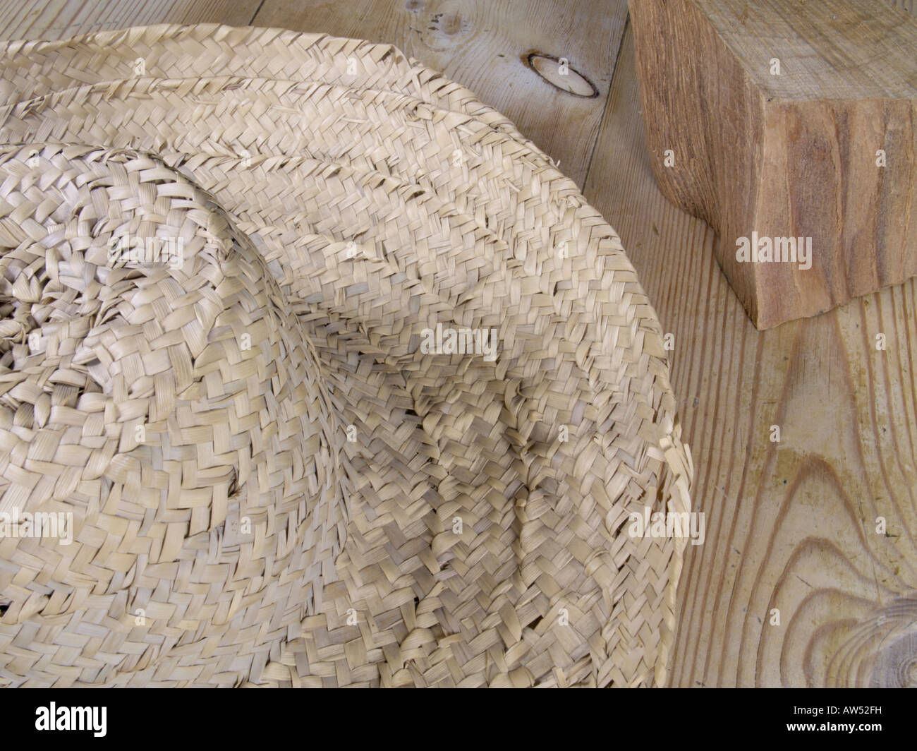 Straw hat and wood block Stock Photo - Alamy