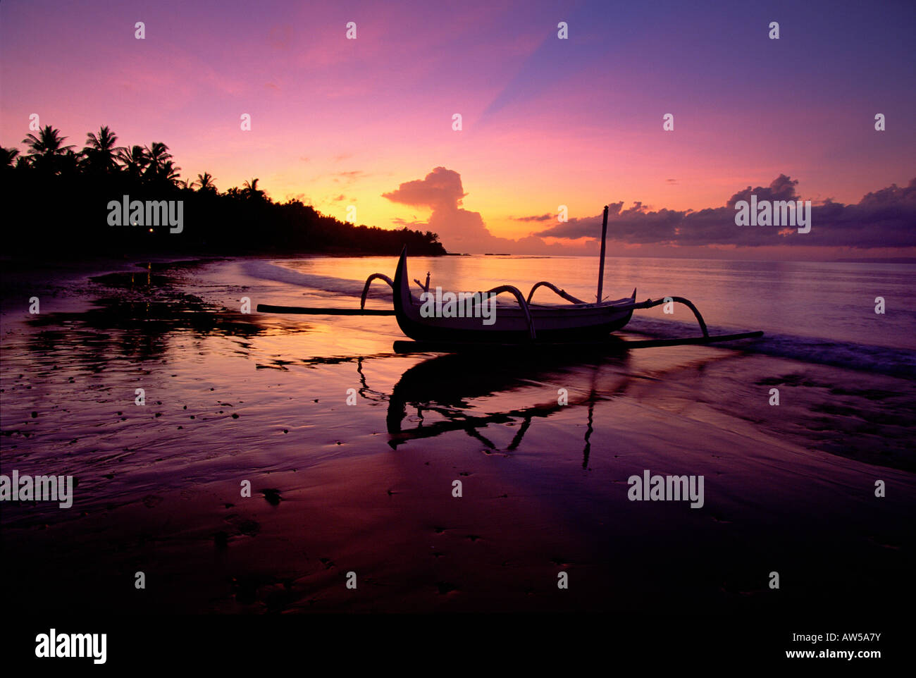 Fishing boat on beach at dawn Stock Photo - Alamy