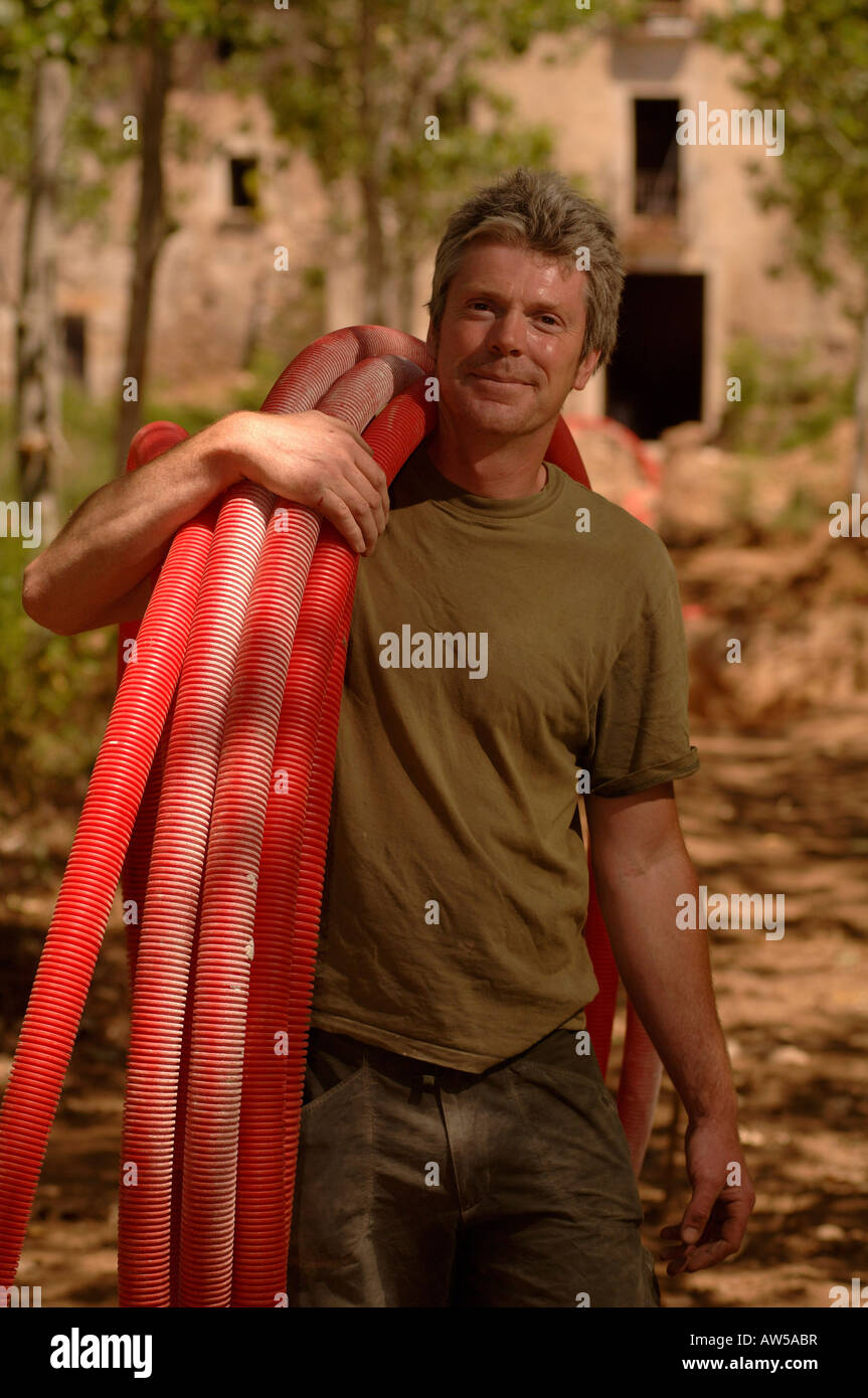 Builder working on rural property Stock Photo - Alamy
