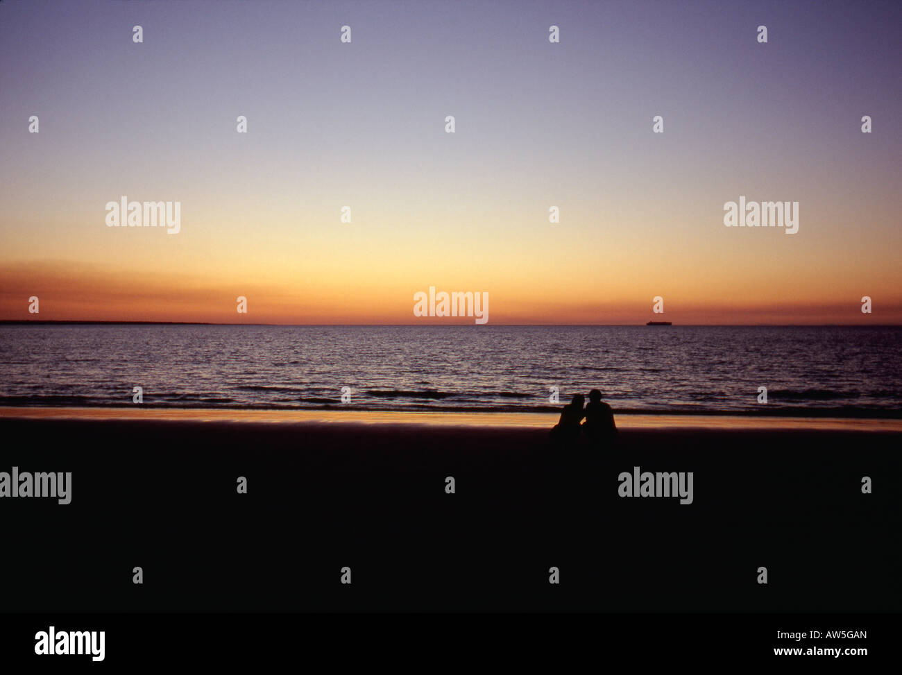 Romantic couple watching red sunset hi-res stock photography and images ...