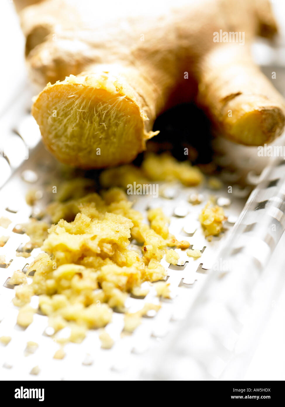grated root ginger in dish with grater Stock Photo - Alamy