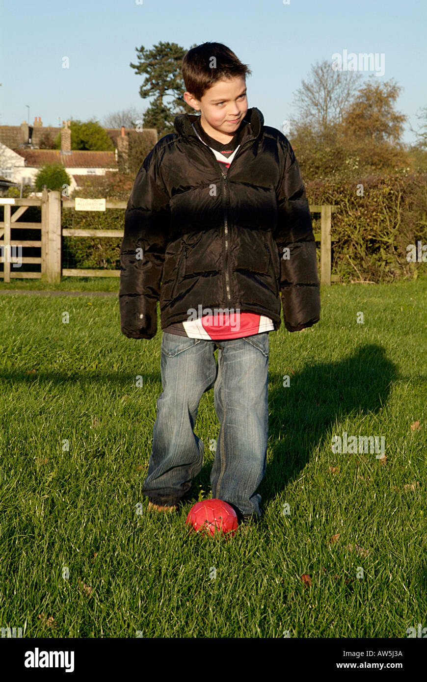 young kid child boy playing football soccer ball kick header heading ...