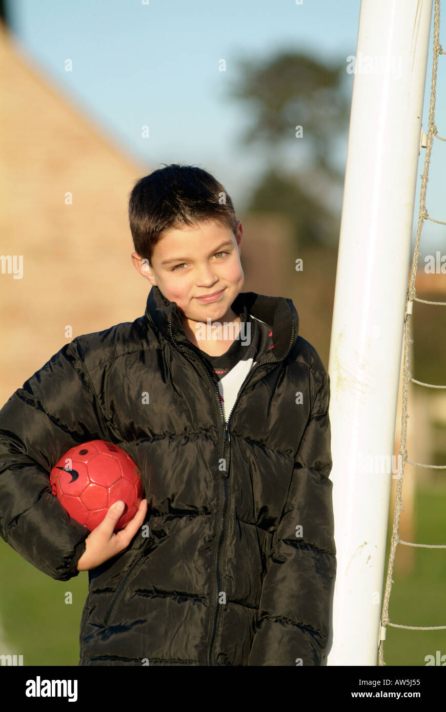 young kid child boy playing football soccer ball kick team sport net ...