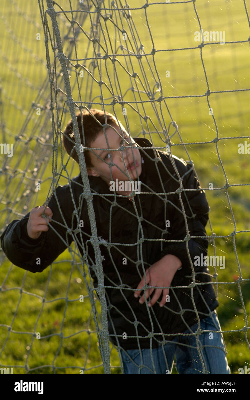 young kid child boy playing football soccer ball kick header heading ...