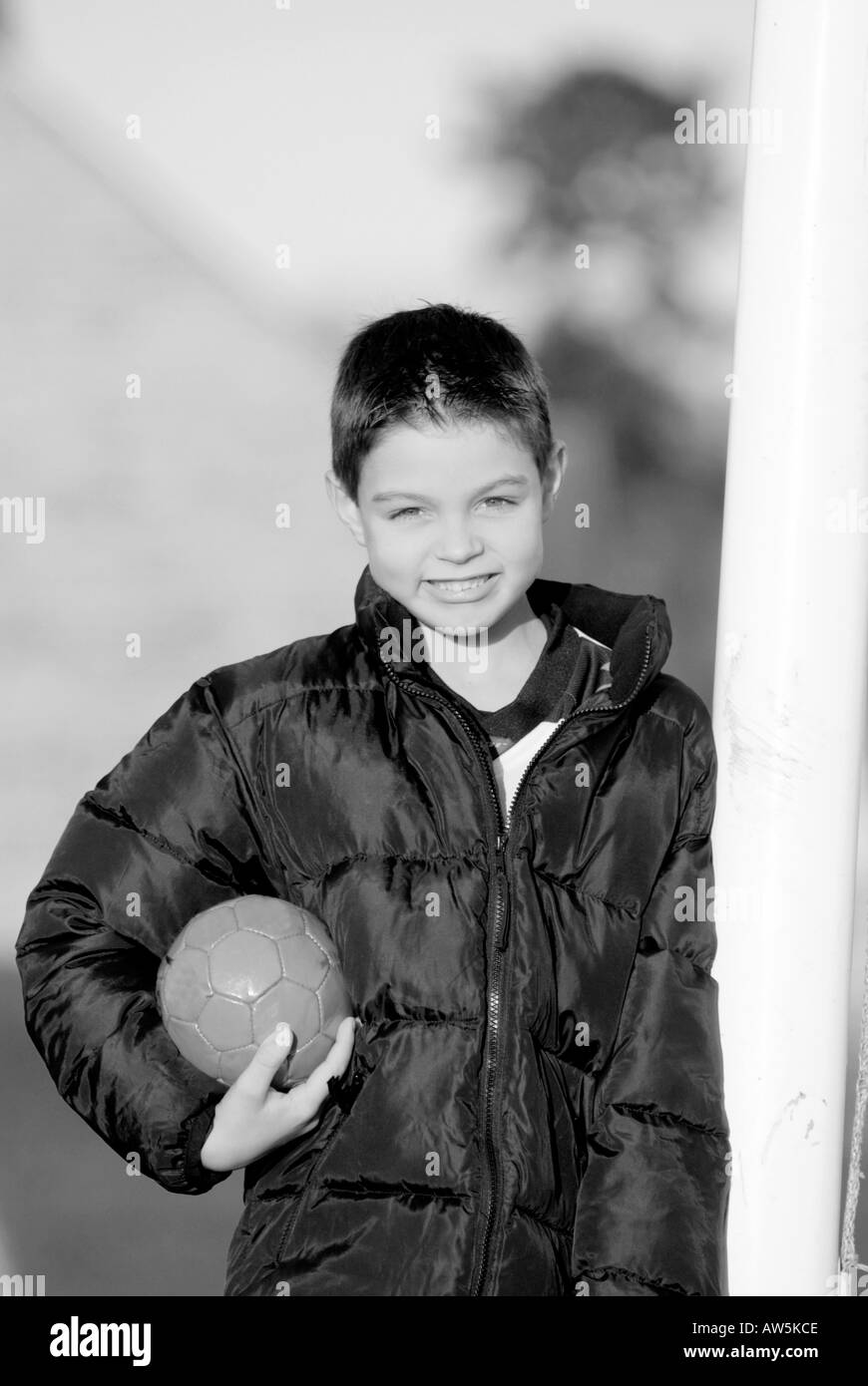 young kid child boy playing football soccer ball kick header heading ...