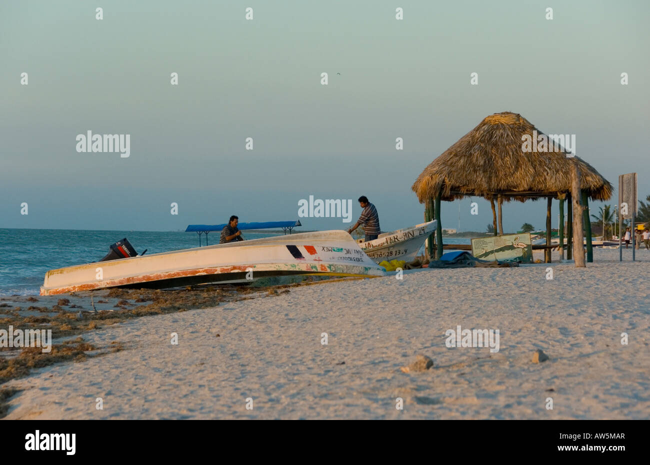 Mexican Men on Beach by Straw Roof Cabana Hut and Upsidedown Boats ...