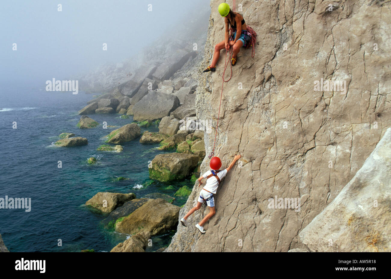 Child learning to climb for the first time Portland Dorset Stock Photo ...