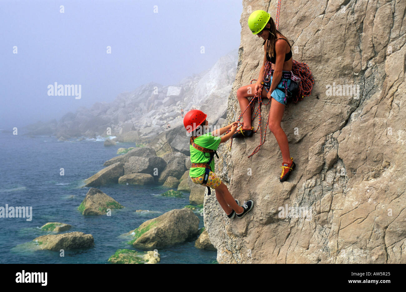 Child learning to climb for the first time Portland Dorset Stock Photo ...
