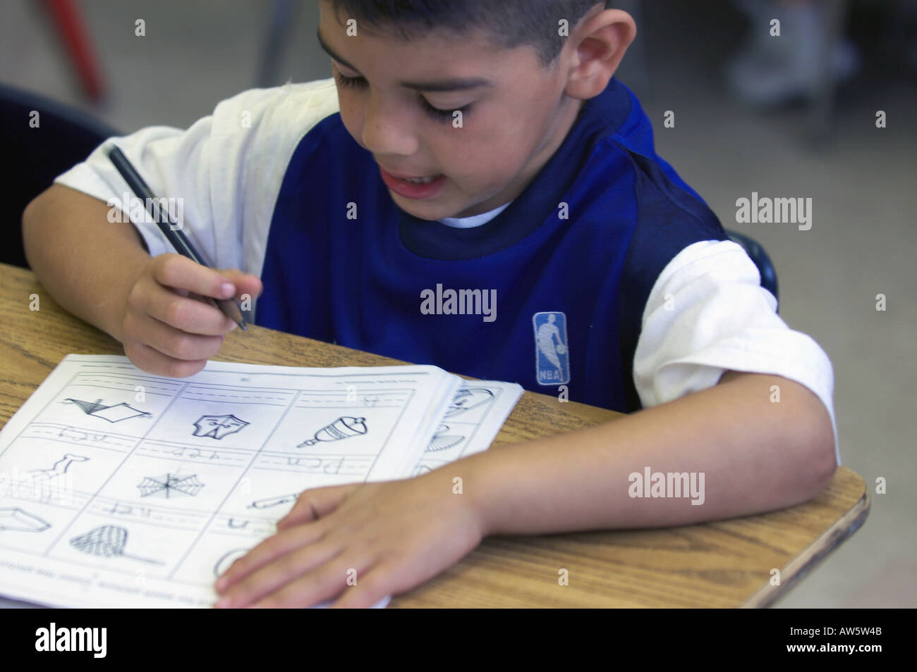 young Hispanic student writing Stock Photo - Alamy
