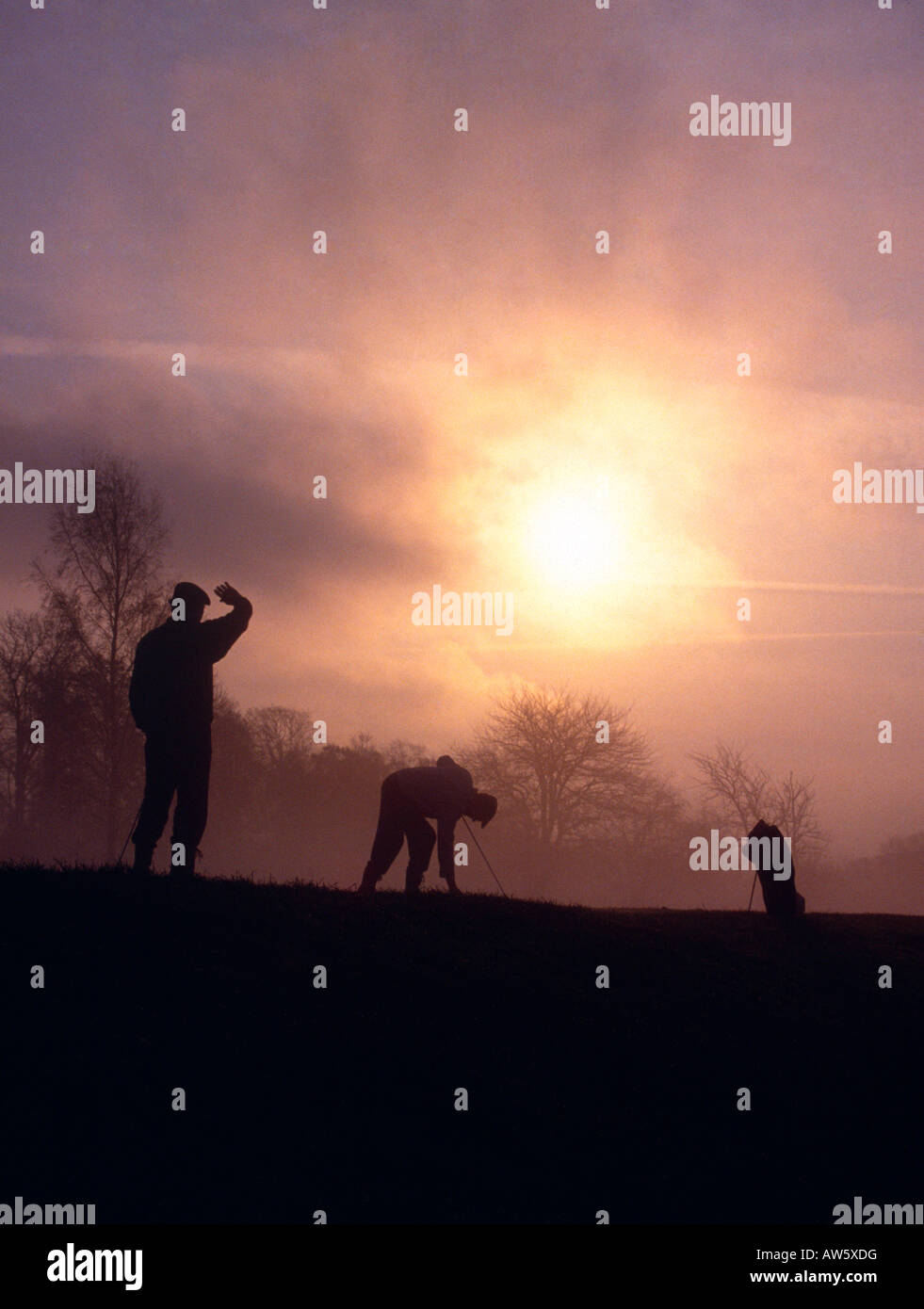 Two friends playing golf year round. The time is about 9.00 in the ...