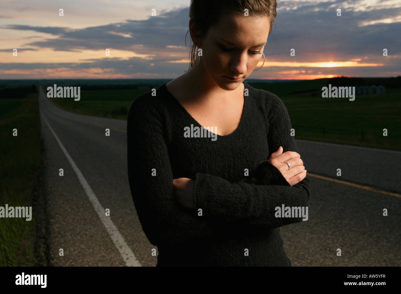 Sad woman beside the road Stock Photo - Alamy