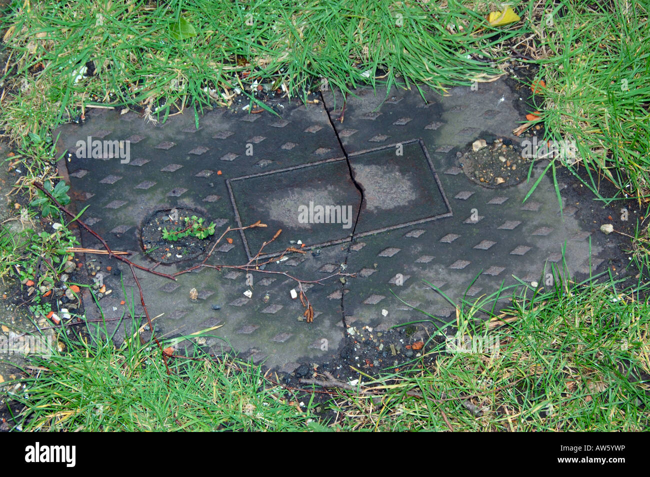 Broken manhole or inspection chamber cover over drain Stock Photo - Alamy