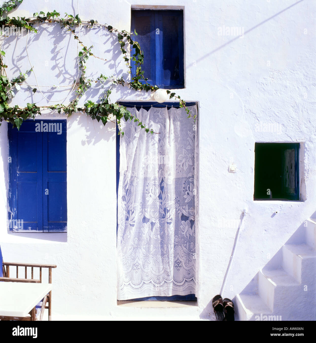 Traditional whitewashed house exterior with blue trim on Santorini in ...