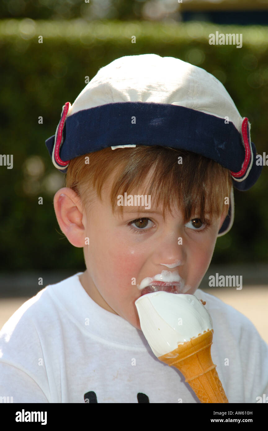 Small boy licking ice cream cone mess all over face messy Stock Photo ...