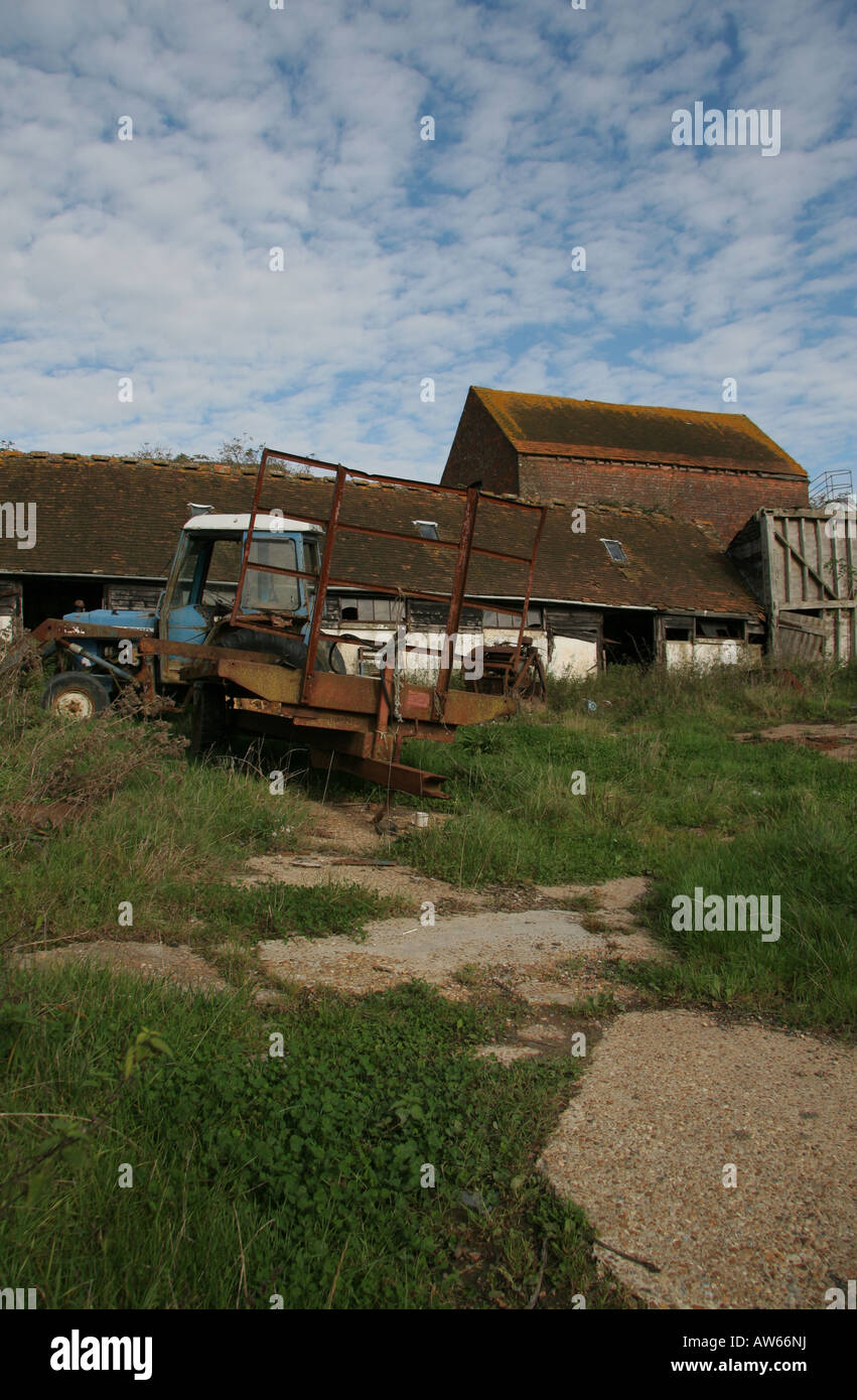 Tumbledown farm with old tractor and ramshackle buildings Stock Photo ...
