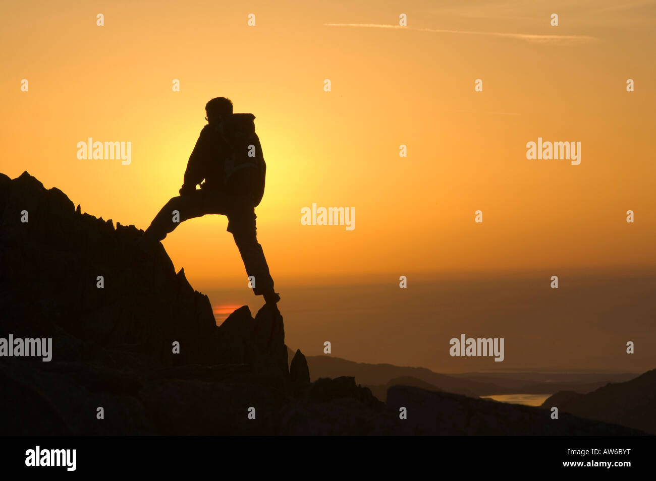 A walker on Swirl howe at sunset Lake District UK Stock Photo - Alamy