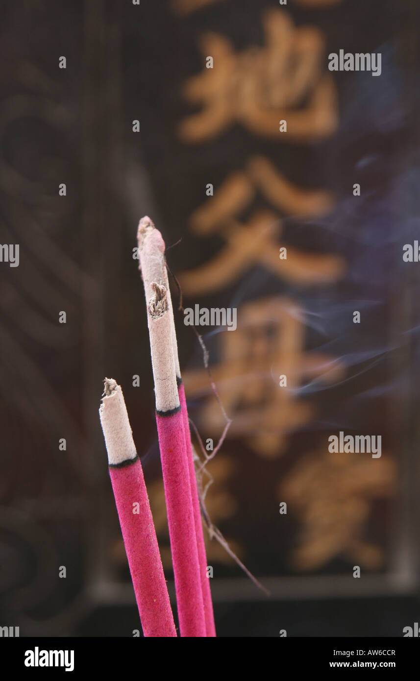 Pink Incense Stick with chinese symbols in the background new year ...