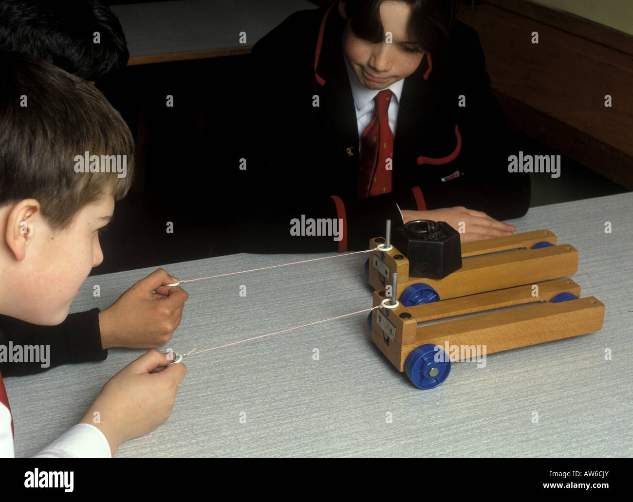 Comparing the accelerations of two different masses when the same force ...
