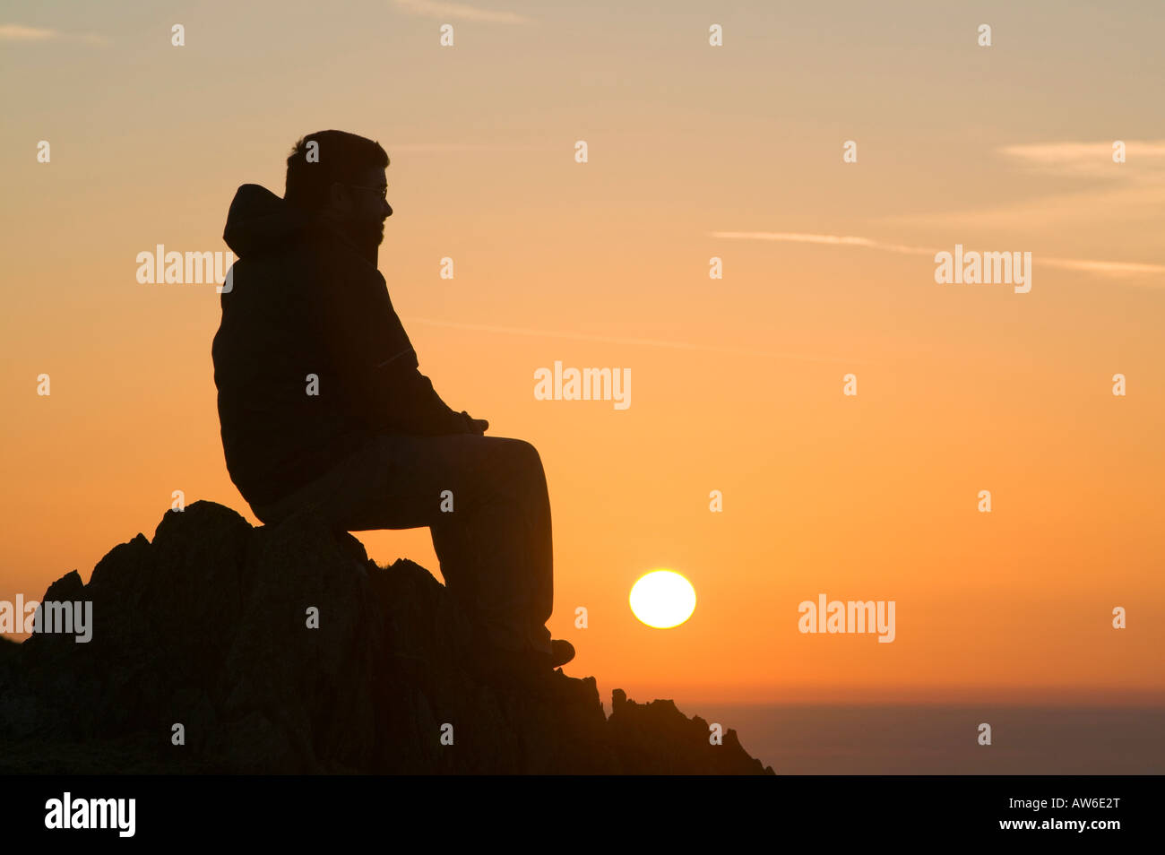 A walker on Swirl howe at sunset Lake District UK Stock Photo - Alamy