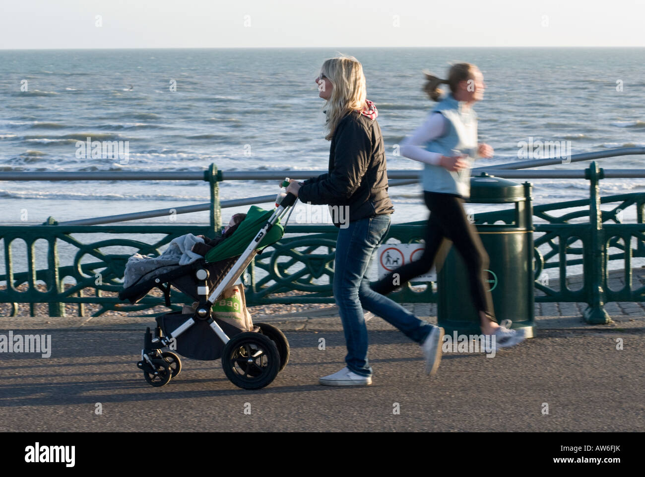 Female Walker Jogger Pushing Buggy Child Stock Photo - Alamy