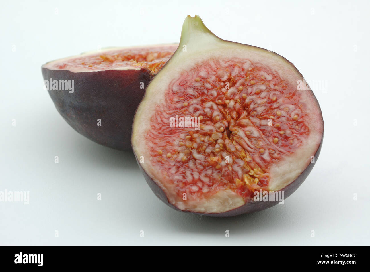 Fig Halved on white background Stock Photo - Alamy