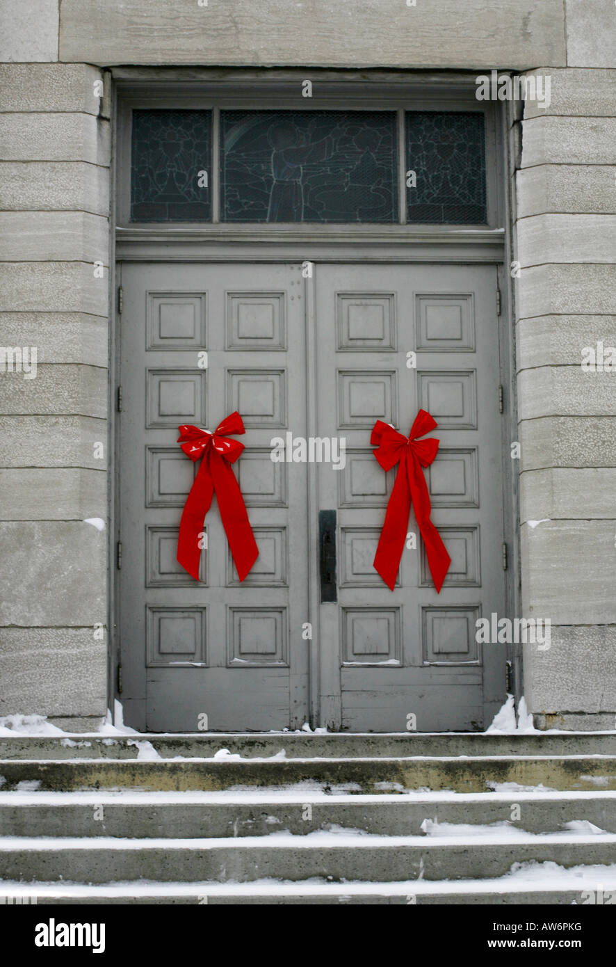 Red bows on doors of a grey building, Waterloo, Quebec Stock Photo - Alamy
