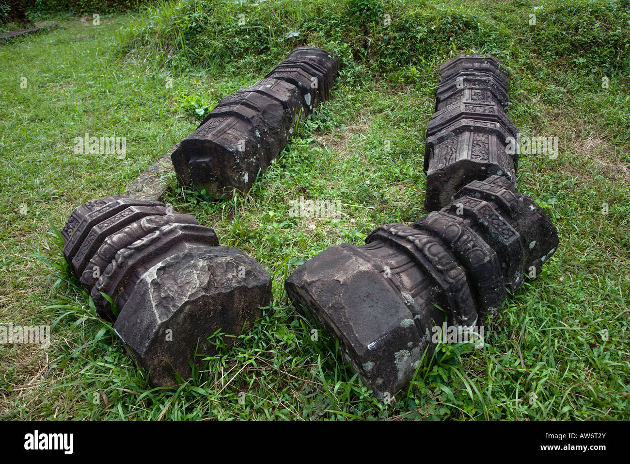 Ancient STONE PILLARS lie on the ground inside the MY SON RUINS CENTRAL ...