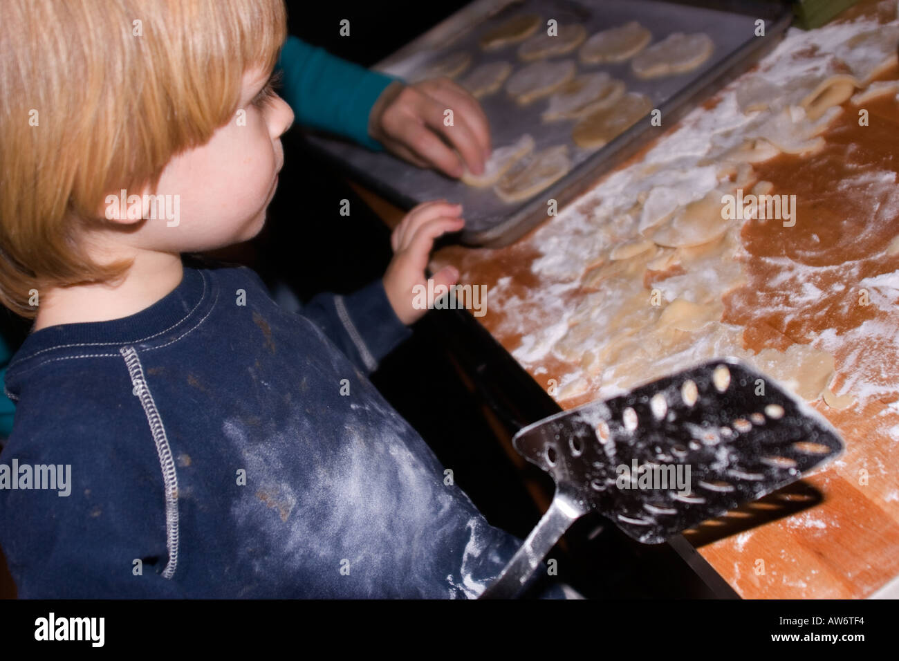 Little boy helping his mother bake cookies Stock Photo - Alamy