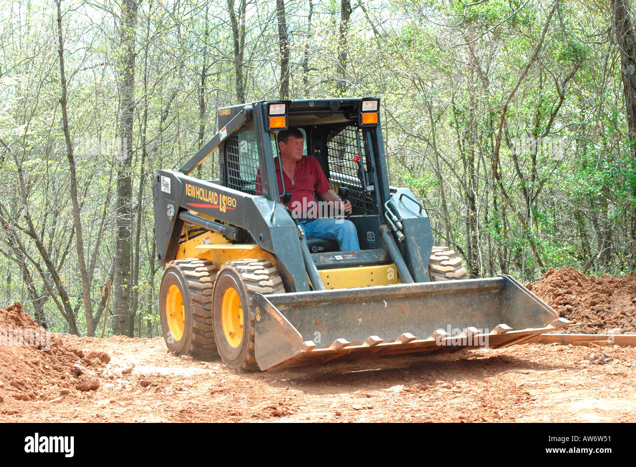 Bobcat driver working on new home construction on the floor of the ...