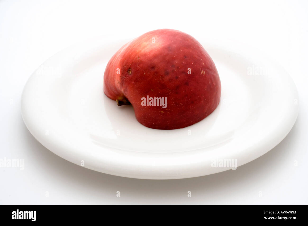 Half apple on dish Stock Photo - Alamy