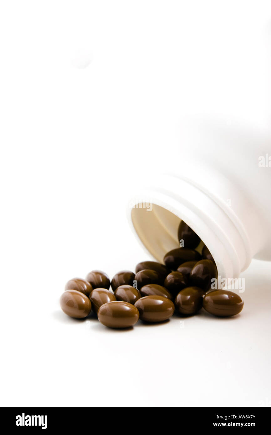 Pills falling out of bottle Stock Photo - Alamy