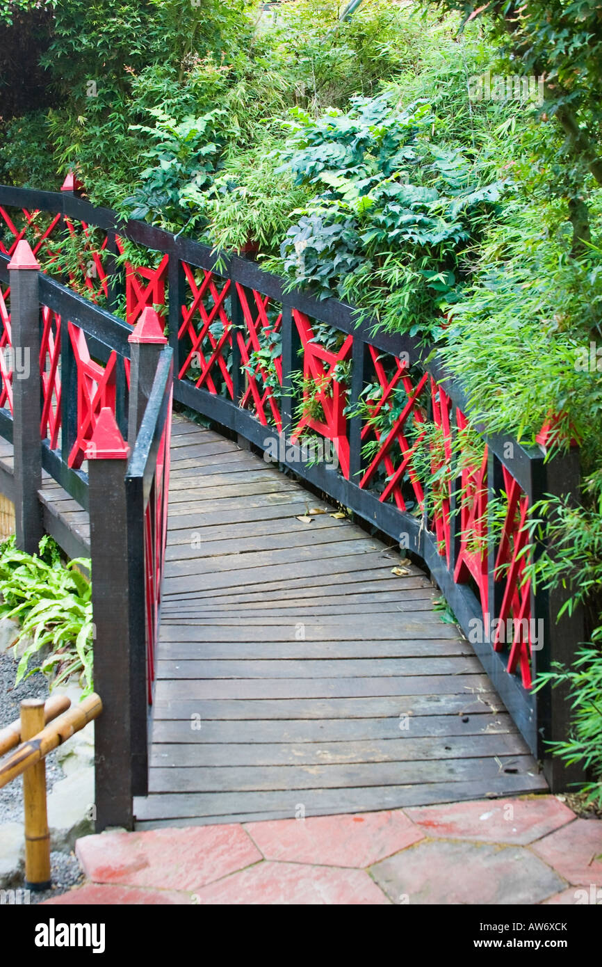 Red and black painted wooden bridge in a Japanese style garden Stock ...