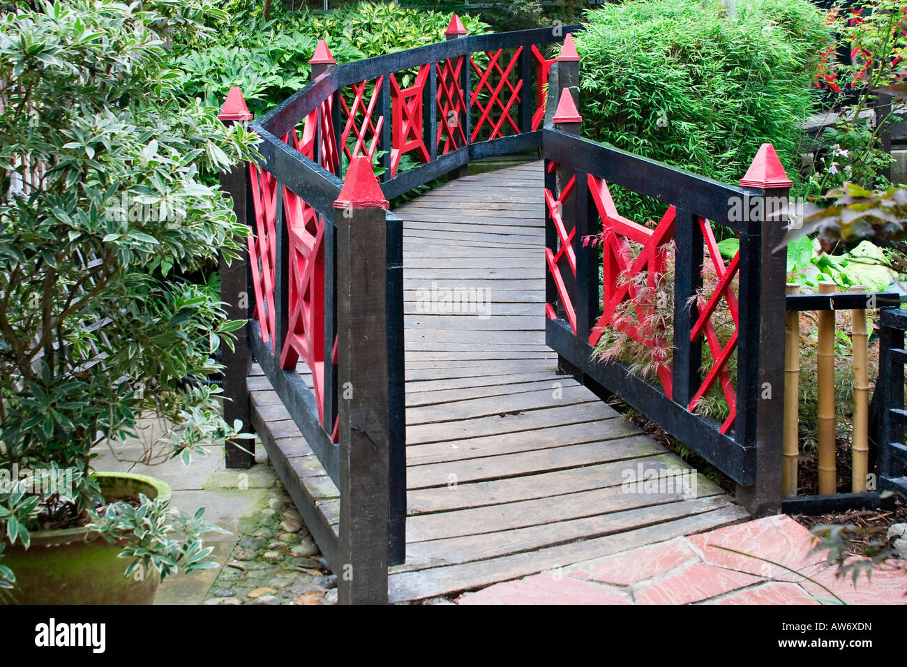 Red and black painted wooden bridge in a Japanese style garden Stock ...