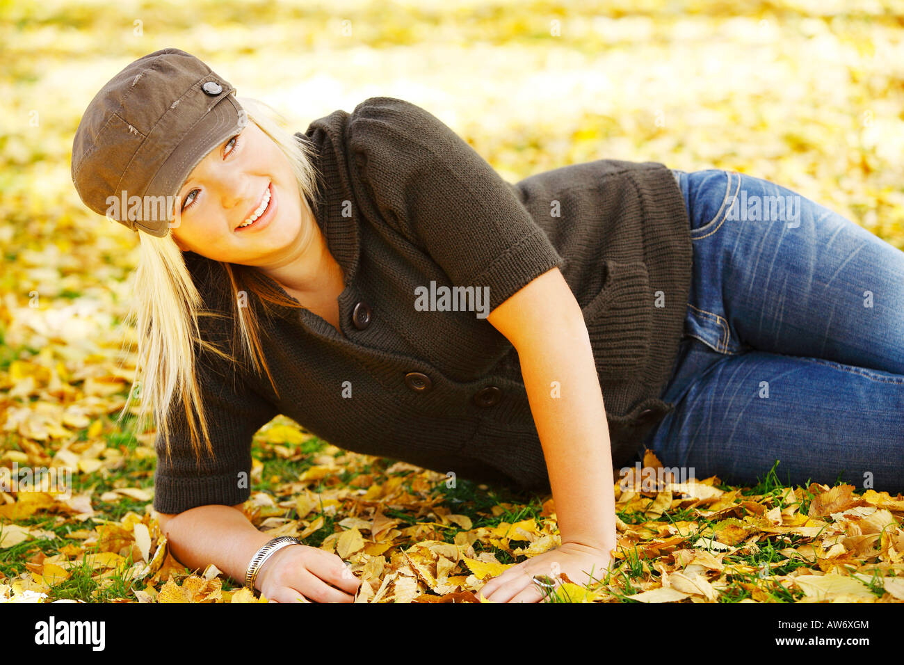 Teenage girl lying on the ground Stock Photo - Alamy