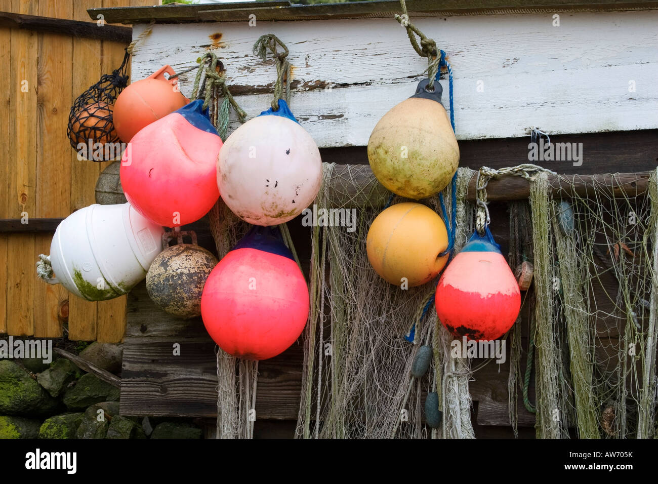 Colourful plastic fishing floats and nets hanging up at Steephill Cove ...