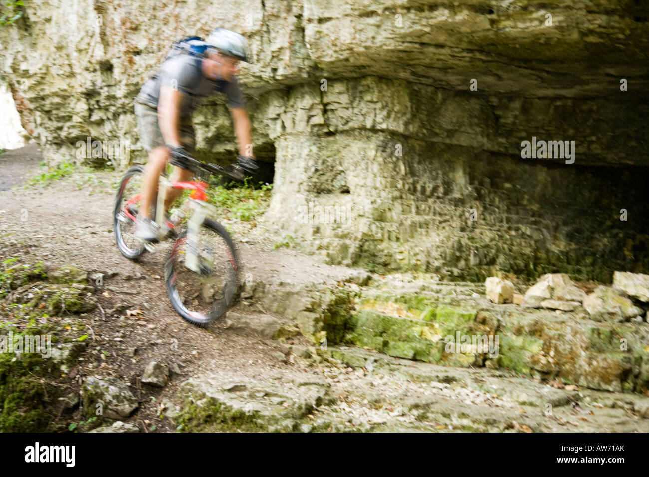 man riding mountain bike alongside river cliff gorge du furon, St ...
