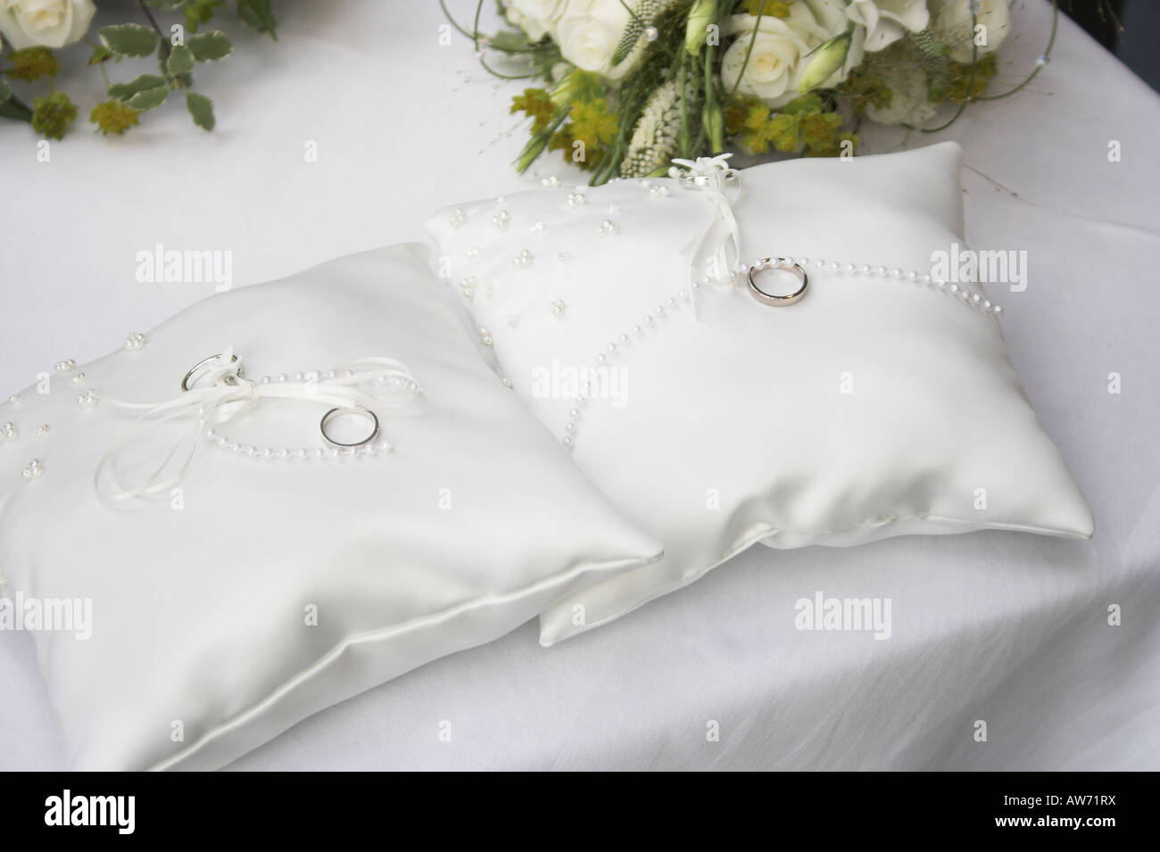 Wedding rings on cushions Stock Photo - Alamy