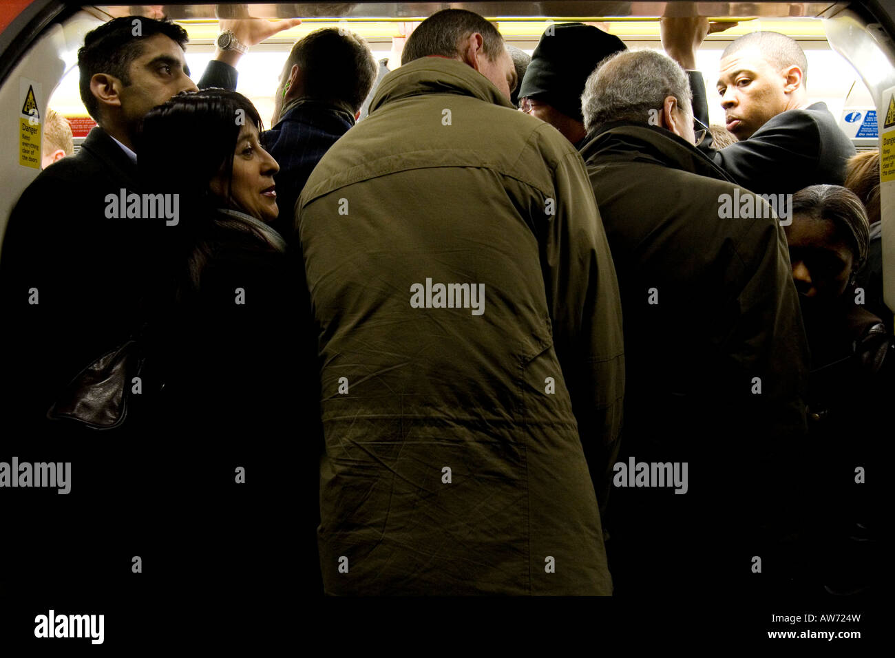 People squash onto a London Underground Train during the morning rush ...