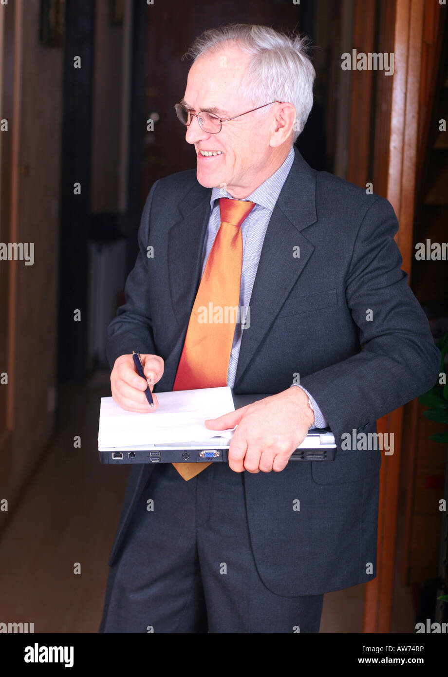 Senior real estate agent taking notes Stock Photo - Alamy