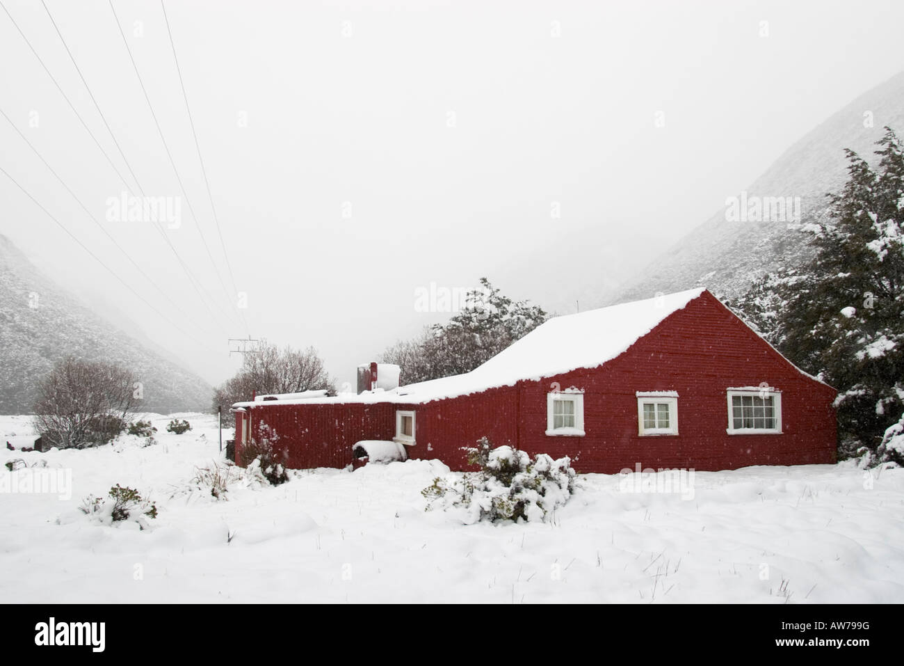 A red farm building in the snow at Arthurs Pass, Canterbury, New ...