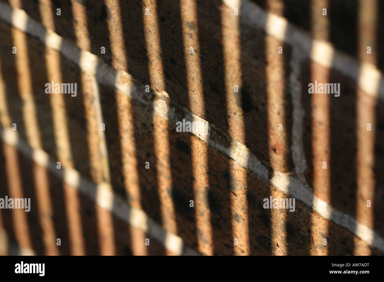 Vertical shadows on brick wall showing crossing pattern Stock Photo - Alamy