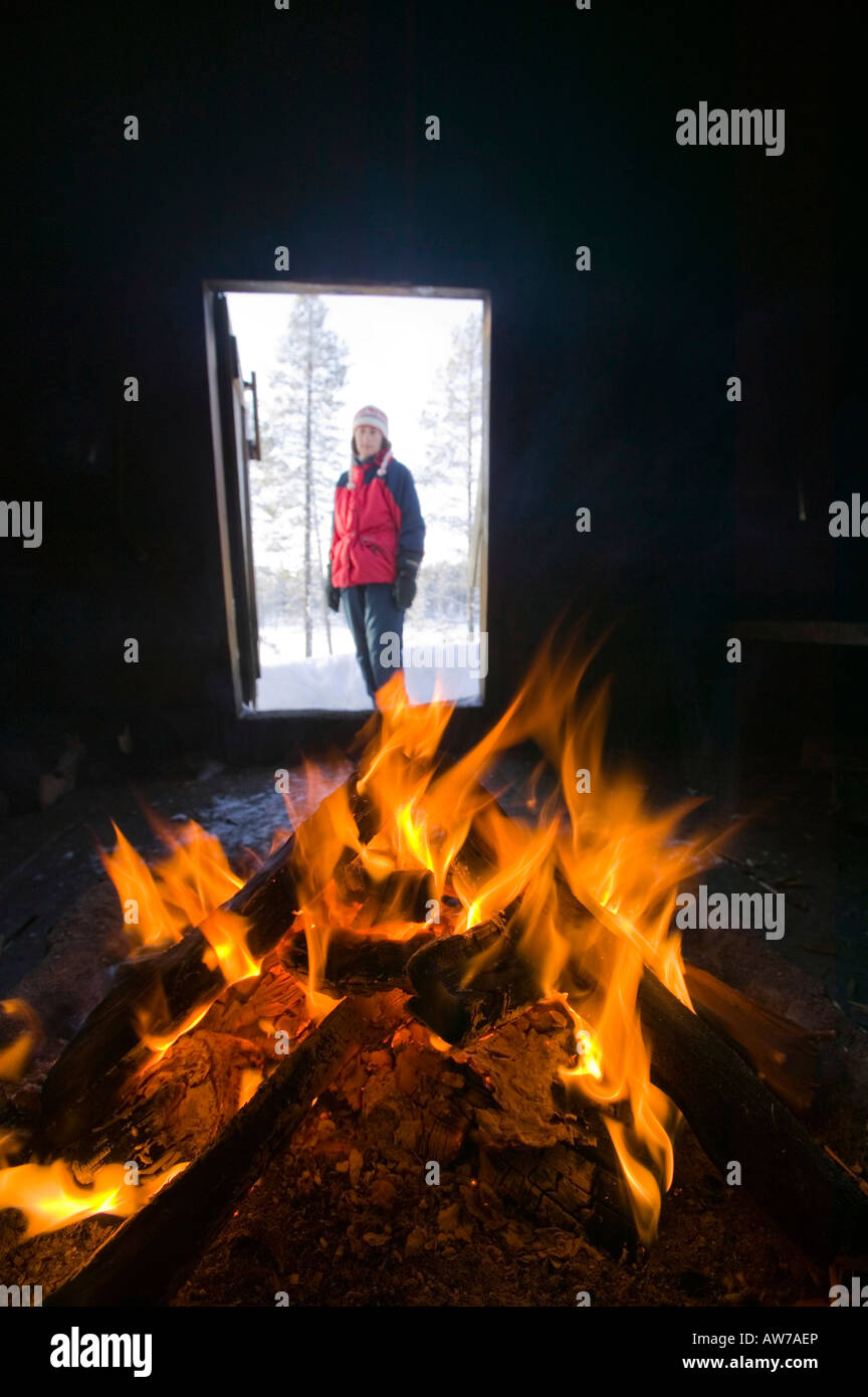 A warming fire in a shelter cabin in the Urho Kehkkosen National Park ...