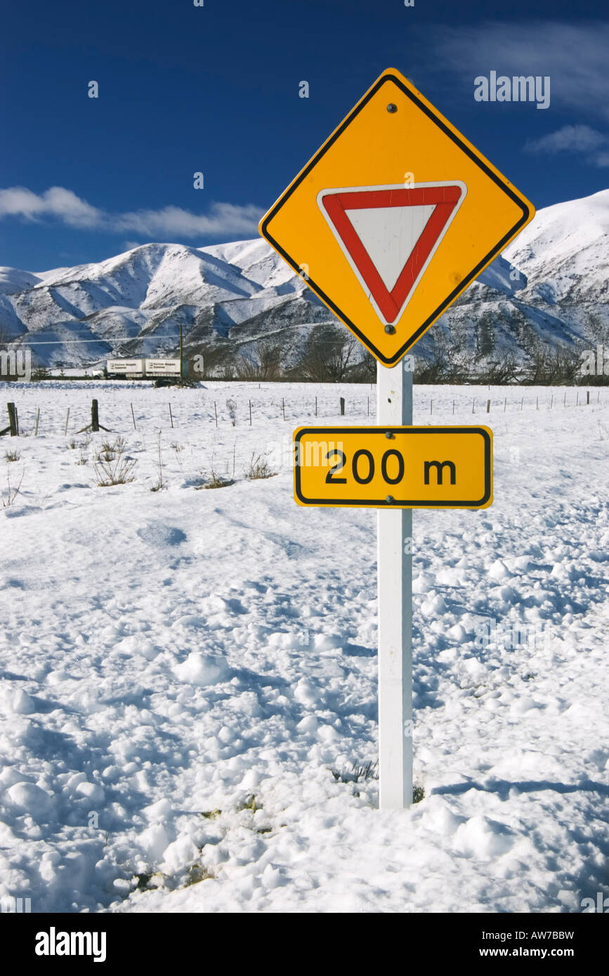 A road sign indicates a junction ahead at which traffic must give way ...