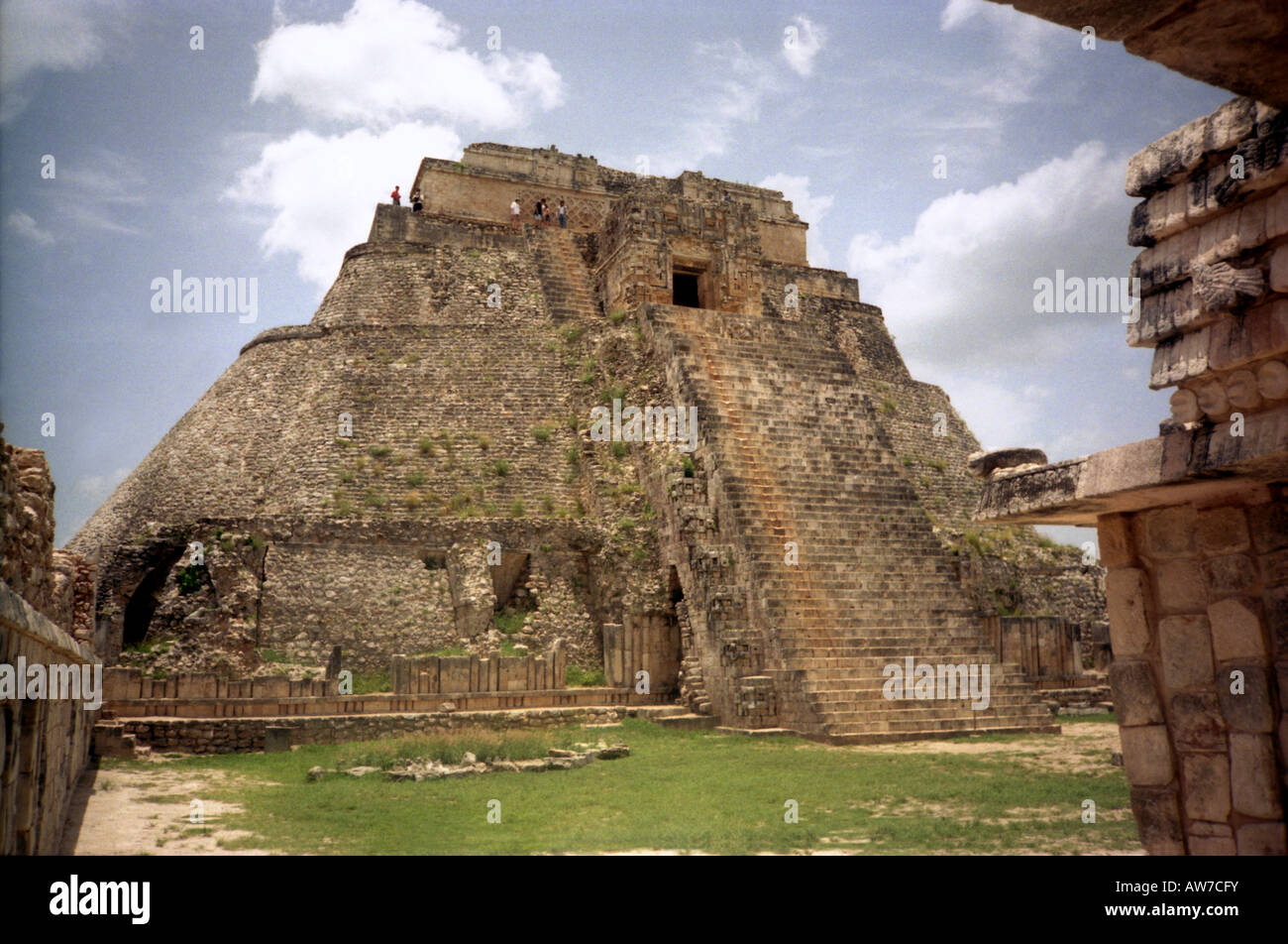 People climbing to top of big steep Maya stone pyramid Uxmal Yucatan ...