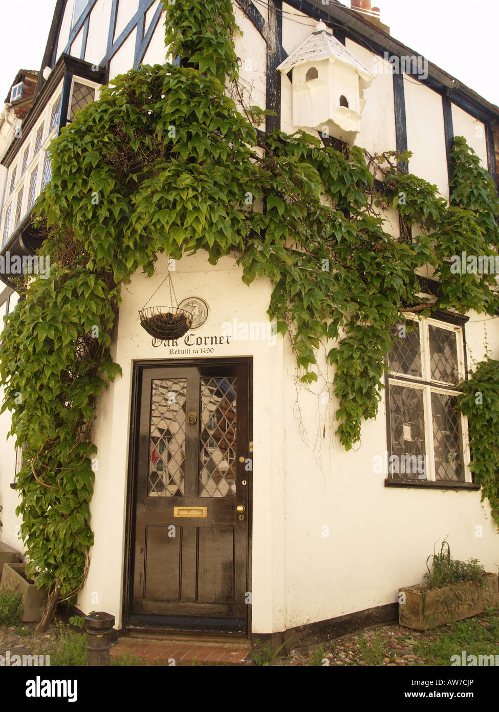white 2 storey green vine covered corner pub Stock Photo - Alamy