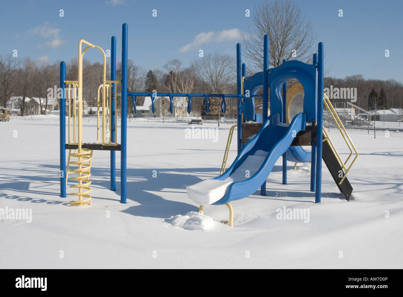 Playground in winter snow on a sunny day without kids, an elementary ...